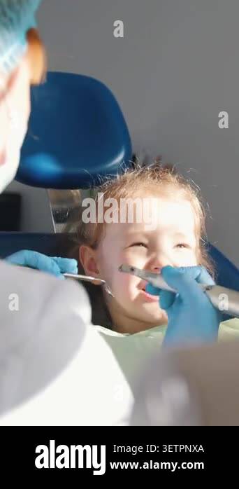 Girl on reception at the dentist, the stomatologist cleaning and ...