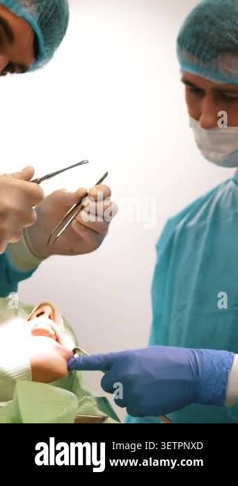 Doctor dentist and assistant during stomatology operation, close up ...