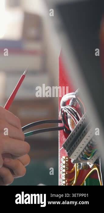 Electricians hands installing energy system on machinery industry ...