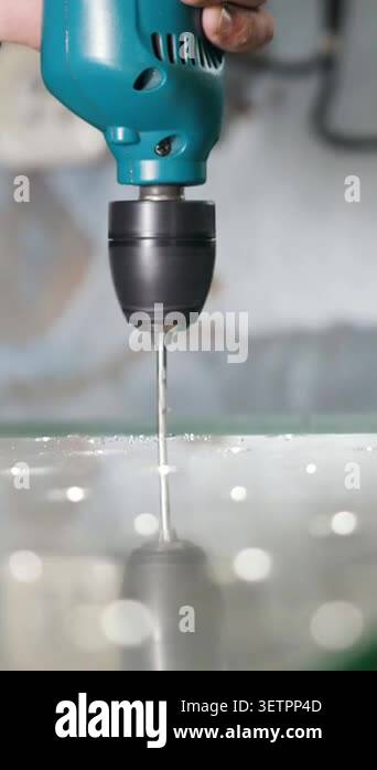 Industrial drilling machine - worker makes holes in metal, close up ...