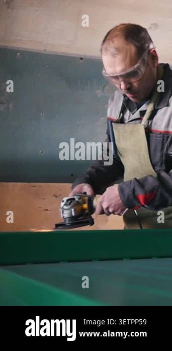 The worker male grinding the steel mechanism on industry, slow-motion ...