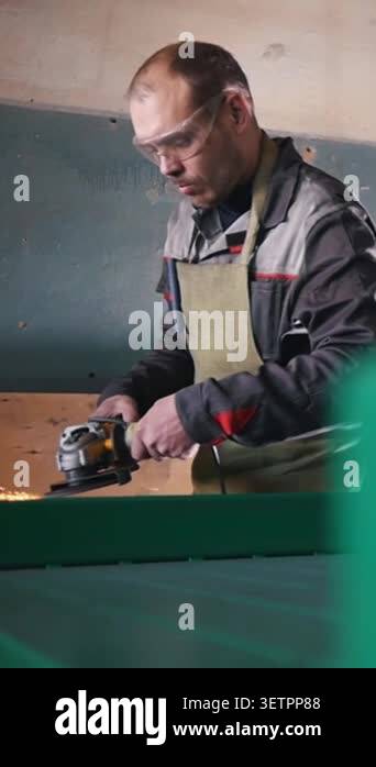 The worker male grinding the steel mechanism on industry, slow-motion ...