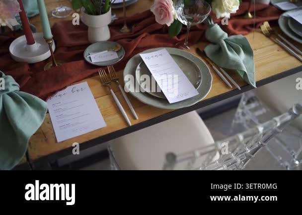 Modern tablescape with menu and folded napkin on ceramic plate event ...