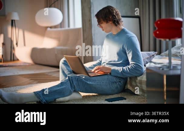 Young freelancer typing laptop working remotely at cozy bedroom ...