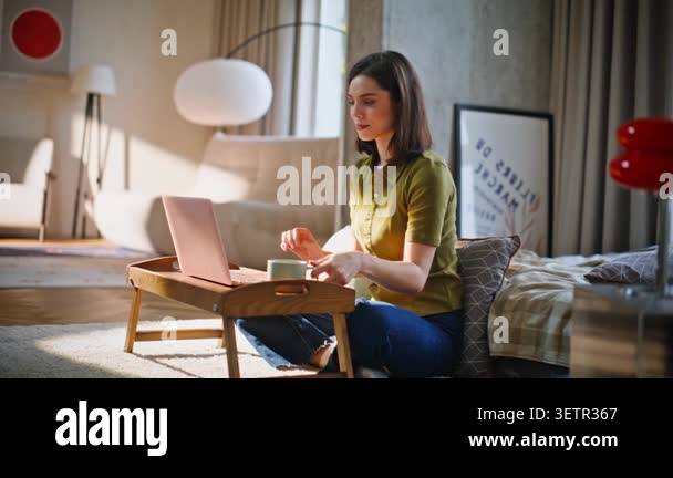 Home businesswoman texting laptop in bedroom sitting floor carpet ...