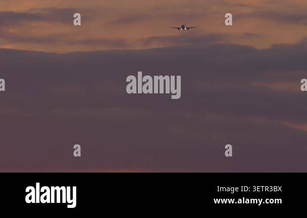 Passenger airplane flying and approaching for landing through dramatic ...