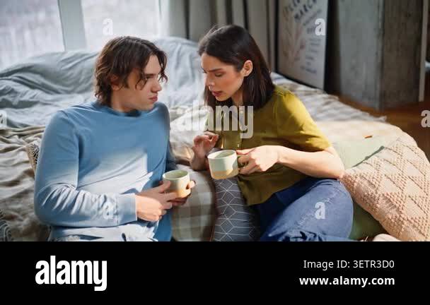 Chatting duet drinking tea at bedroom interior closeup. Calm man ...