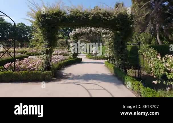 Beautiful arches made of plants with colorful flowers in the Retiro ...