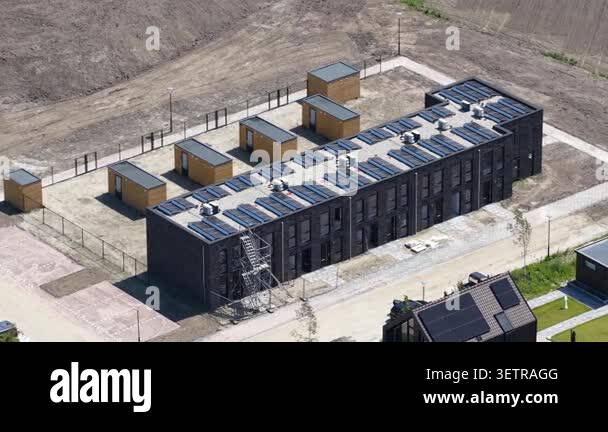High angle drone shot showing a newly constructed apartment block with ...