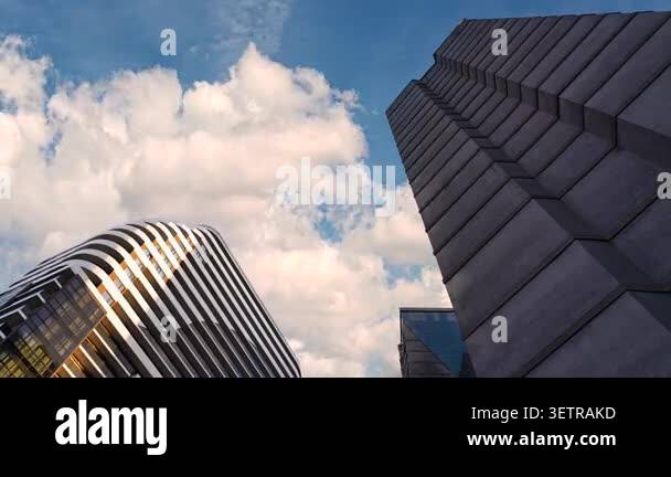 Dramatic low-angle timelapse showing fluffy white clouds drifting ...