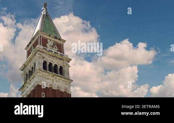 Timelapse of white fluffy clouds moving across a blue sky behind the ...