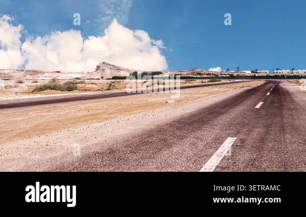 Timelapse showing an empty asphalt road winding through the marsa alam ...
