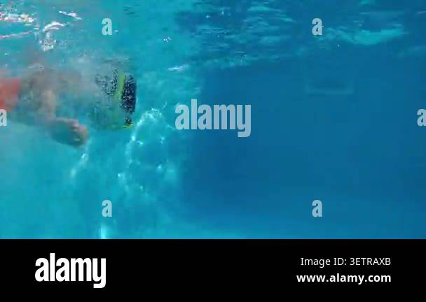 Shot of a happy little boy wearing tuba mask while swimming underwater ...