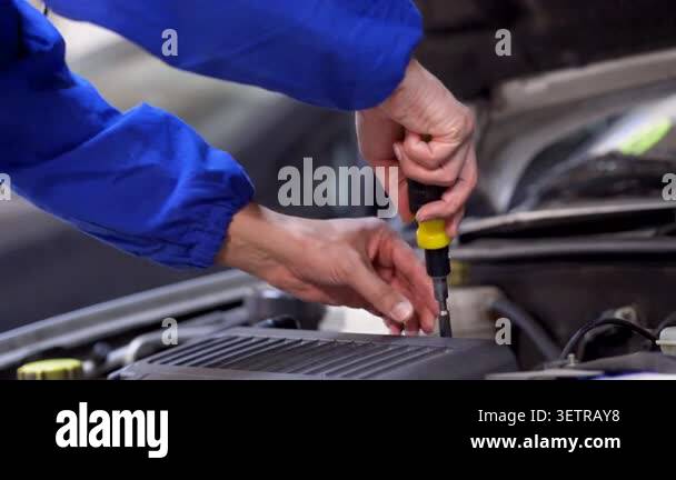 car mechanic hands and screwdriver tools working on automobile ...