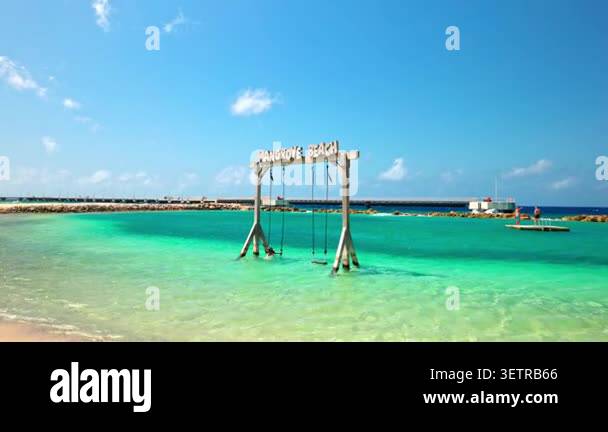Beautiful view of child near swings at Mangrove Beach in Caribbean Sea ...