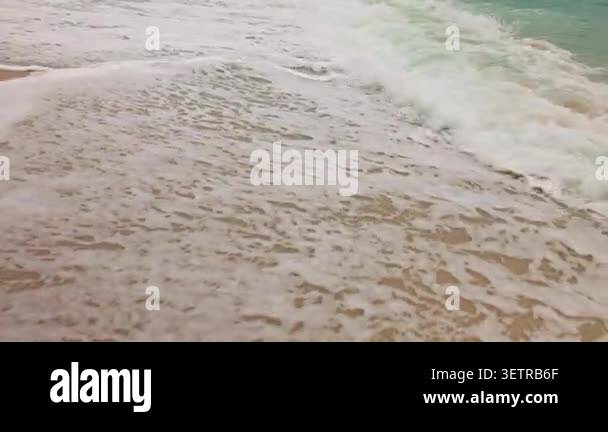 Close-up view of Atlantic Ocean waves washing sandy beach shoreline ...