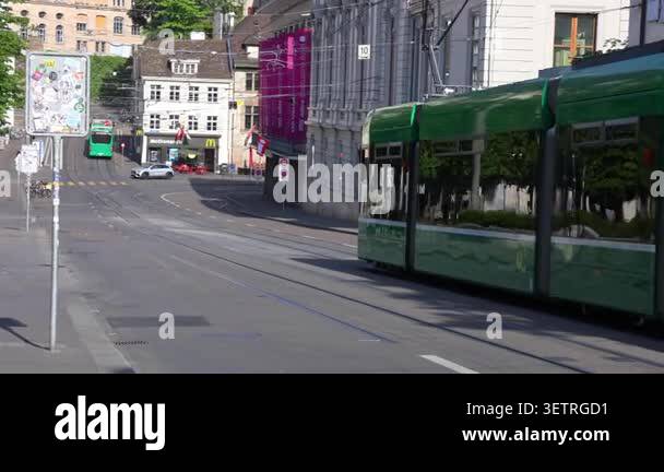 Basel, Switzerland, May 24, 2026: Green tram approaches intersection on ...