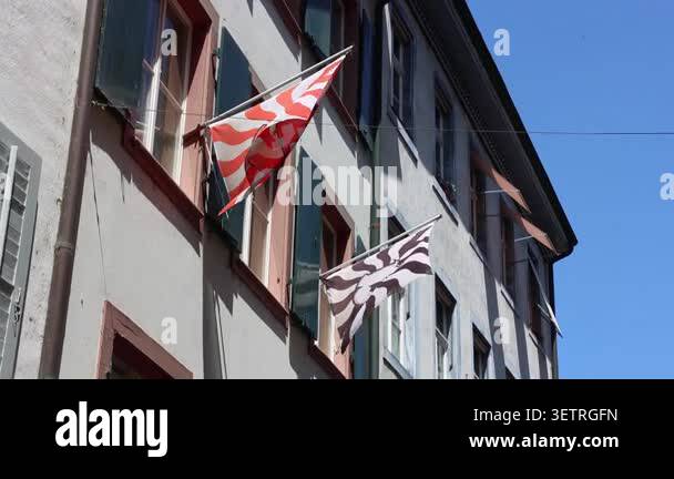 Basel, Switzerland, May 24, 2026: Colorful flags with red and white ...