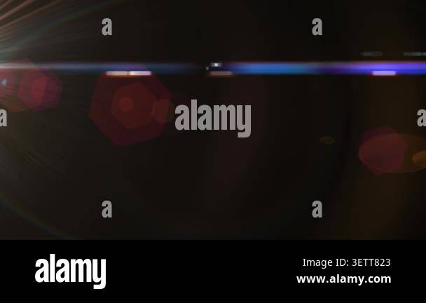 Light rays and lens flare effects with bokeh highlights against a dark ...