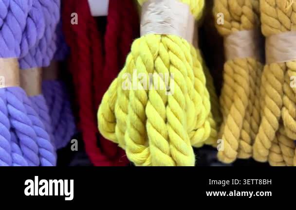 Different shades of threads hang in a craft store. People can choose ...