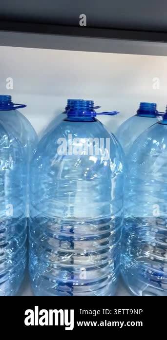 People see rows of clear water bottles neatly arranged in a supermarket ...