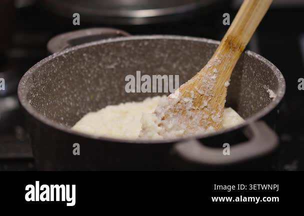 Cooking ghomi, a popular dish from the Samegrelo region made with ...