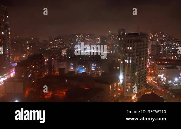 Glowing city lights illuminating a dense urban landscape at night with ...