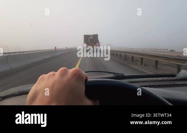 Driver's perspective following an oversize load truck on a highway ...