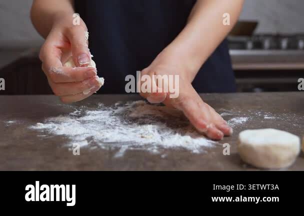 Unrecognizable woman's hands kneading and shaping a small piece of ...