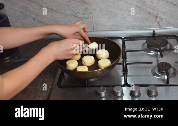 Female hands preparing traditional eastern european syrniki, flipping ...