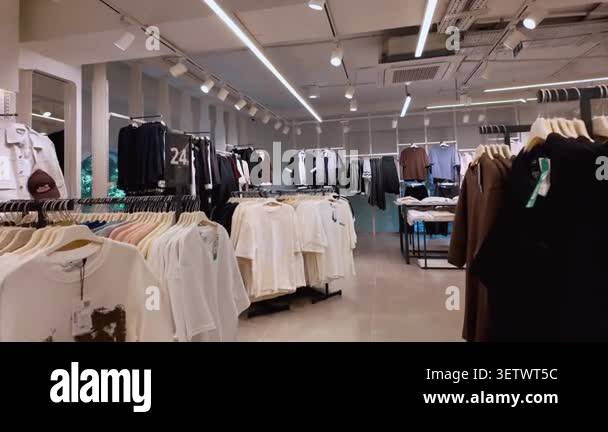 Wide variety of stylish casual wear and modern fashion hanging on racks ...