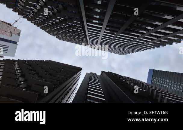Dynamic urban shot moving along the towering facades of contemporary ...