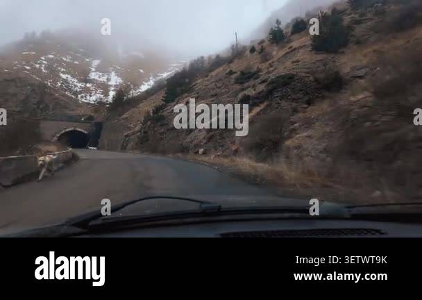 Point of view shot from a vehicle driving along a winding mountain pass ...