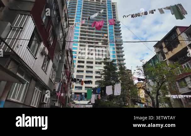 Colorful laundry hanging on clotheslines to dry between an old ...