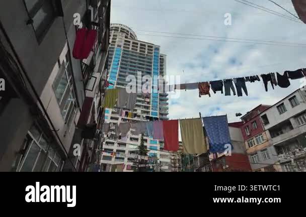 Wet laundry hanging on clotheslines strung between old residential ...