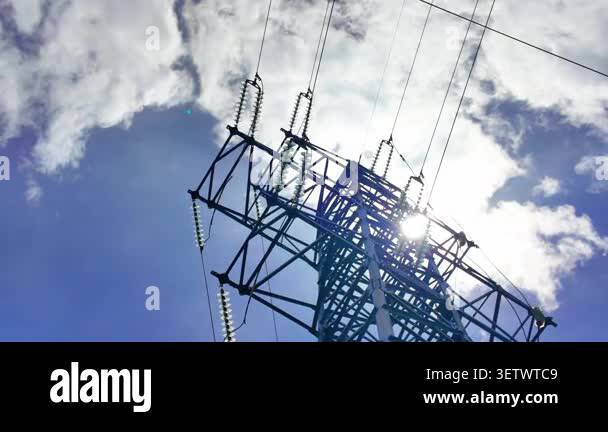 Tall steel lattice pylon carrying high-voltage electricity lines ...