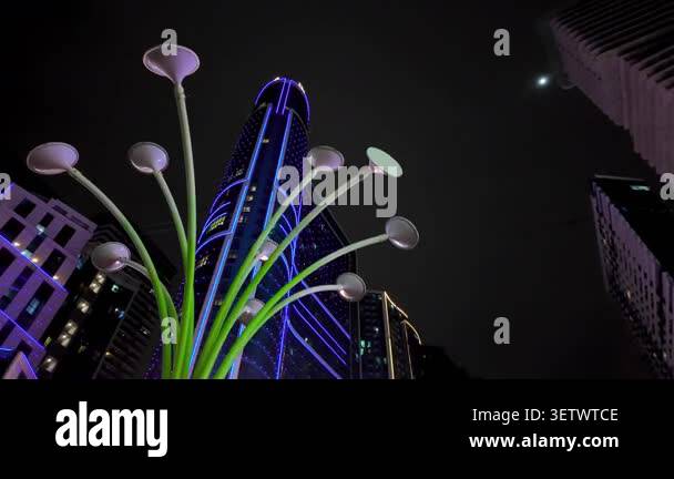Modern skyline at night with purple and pink neon-lit skyscrapers and ...