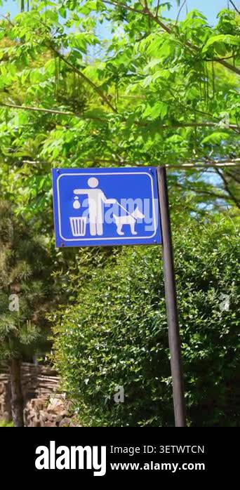 Blue sign reminding dog owners to clean up after their pets and keep ...