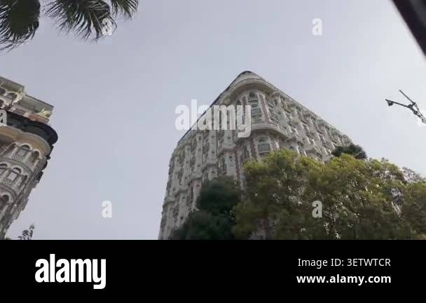 Low-angle view from a moving car showing the iconic wukang building ...