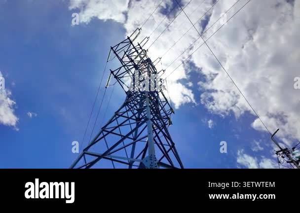 Towering high-voltage electricity pylon with glass insulators ...