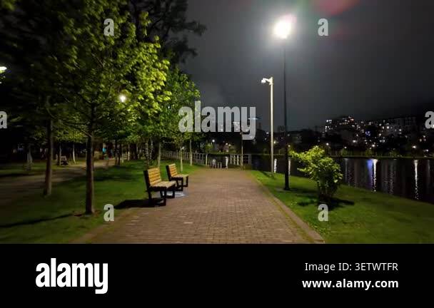 First-person perspective walking along an empty illuminated pathway in ...