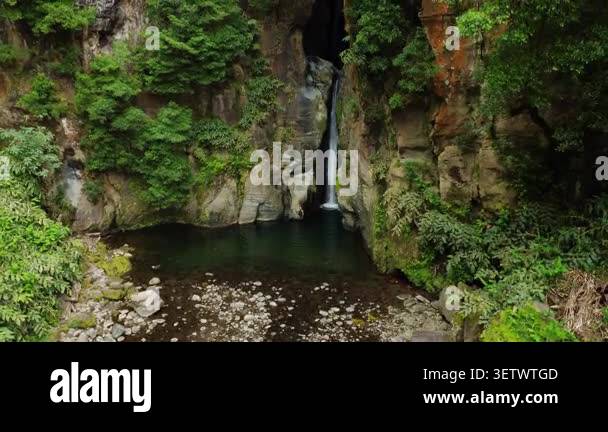 Aerial view ascending over the salto do cabrito waterfall in a lush ...
