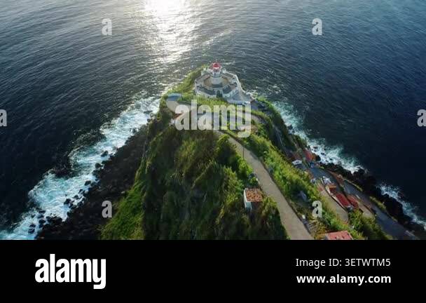 Aerial footage of the historic arnel lighthouse on a cliff in sao ...
