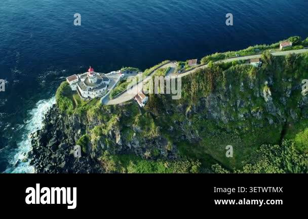 Aerial view of the arnel lighthouse on a dramatic rocky cliffside in ...