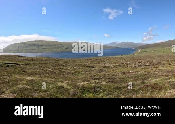 A stunning 4K cinematic wide shot of Srvgsvatn (Leitisvatn) on Vgar ...