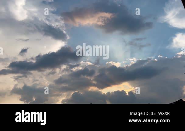 Beautiful Dramatic Sky with Golden Sunlight Beams and Moving Clouds at ...