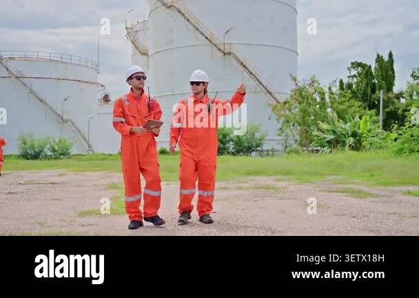 Professional male industrial engineer team wearing orange safety ...