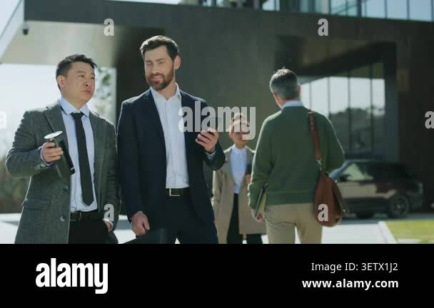 Handsome two business men walking talking discussing on street in ...