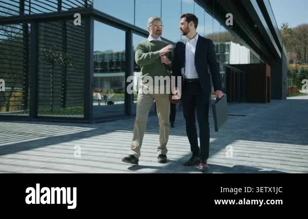 In this video, businessmen navigate the city, showcasing urban life ...