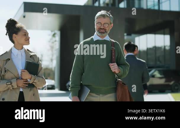 Happy smiling two business people walking talking. Young woman have ...